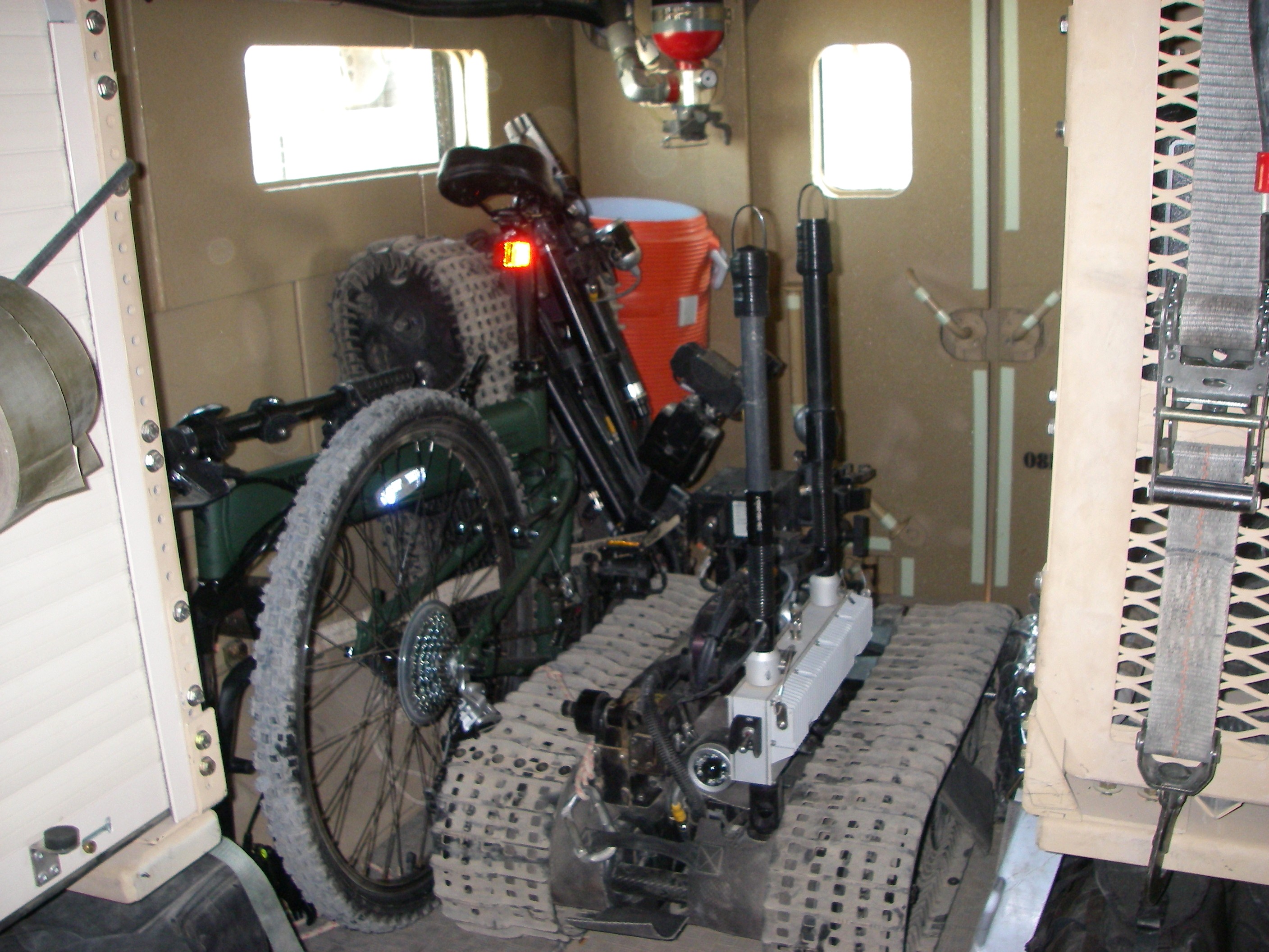 Paratrooper bike folded next to a robot inside an MRAP | Montague Bikes